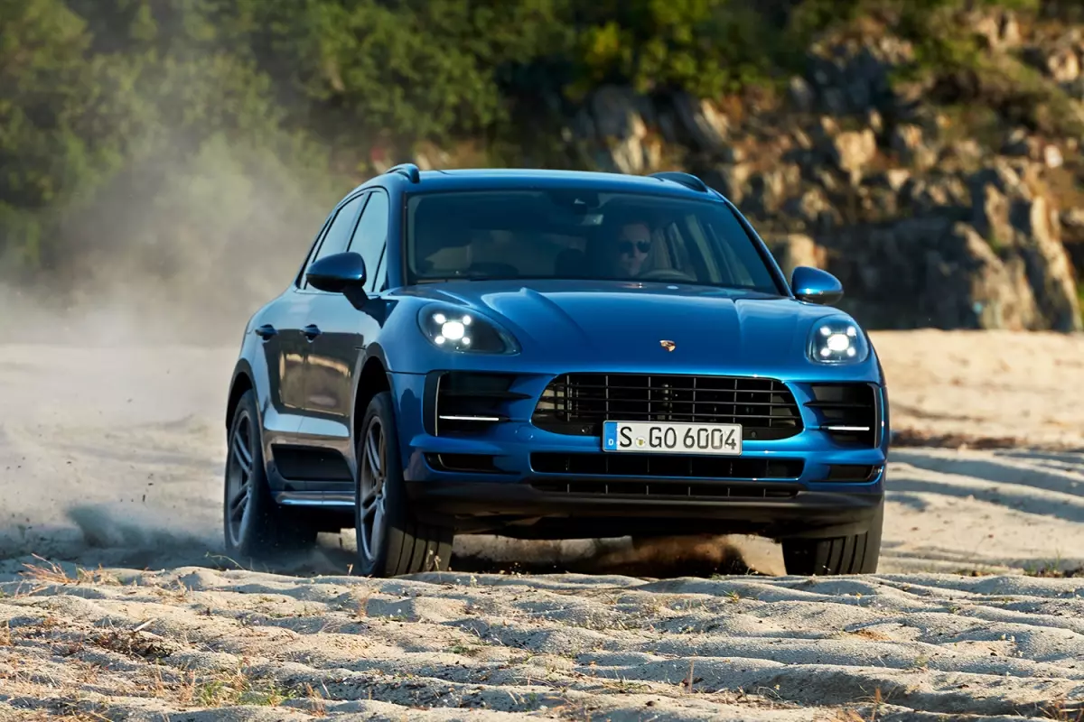 Naujasis mėlynos spalvos visureigis „Porsche Macan“ važiuoja smėliu