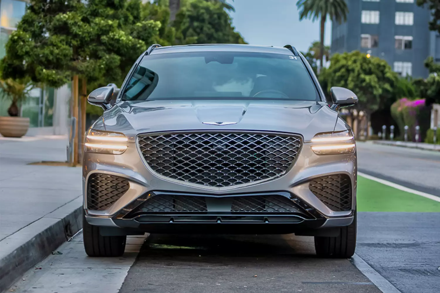 De foarkant fan 'e Genesis GV70 SUV mei in grut grille en cheetah-krasljochten